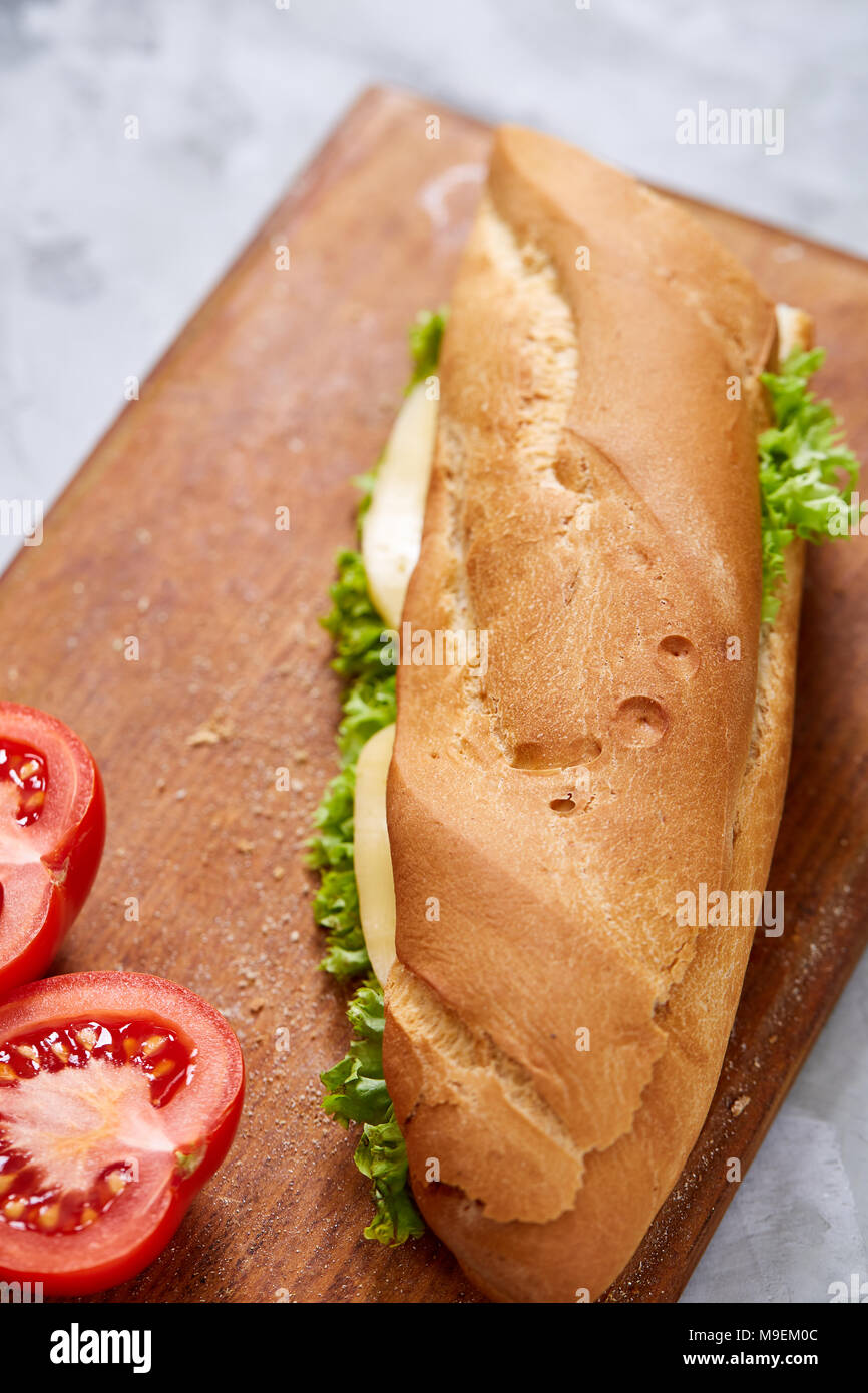 Fresh and tasty submarine sandwich with cheese and vegetables with ...
