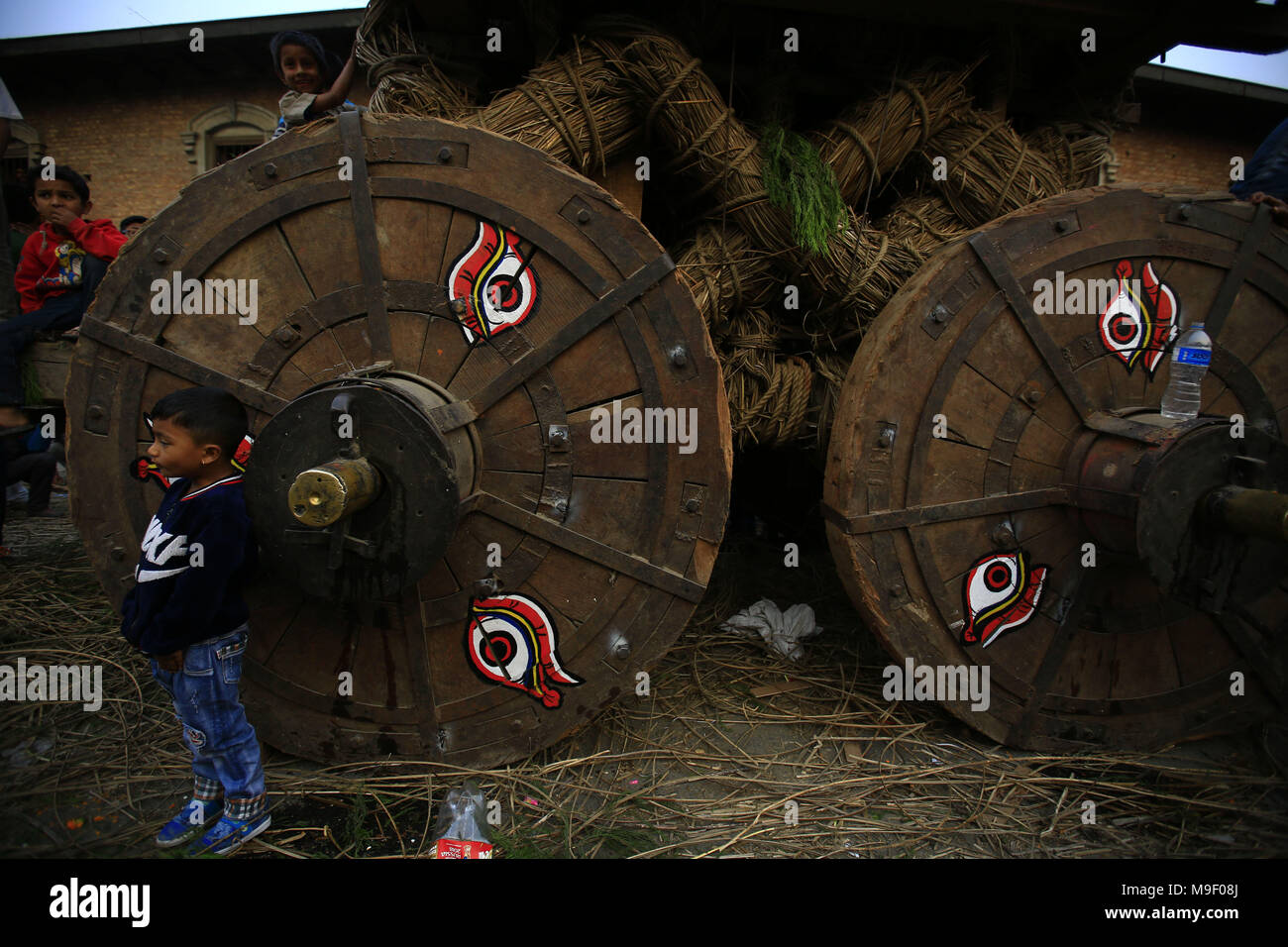 Kathmandu, Nepal. 25th Mar, 2018. A boy stands in front of the wheels ...
