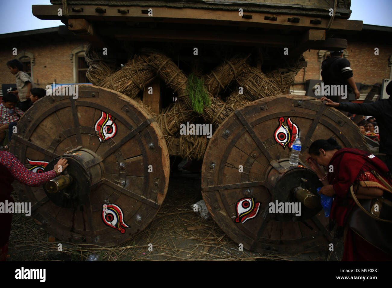 Kathmandu, Nepal. 25th Mar, 2018. Women offer prayers on the wheels of ...