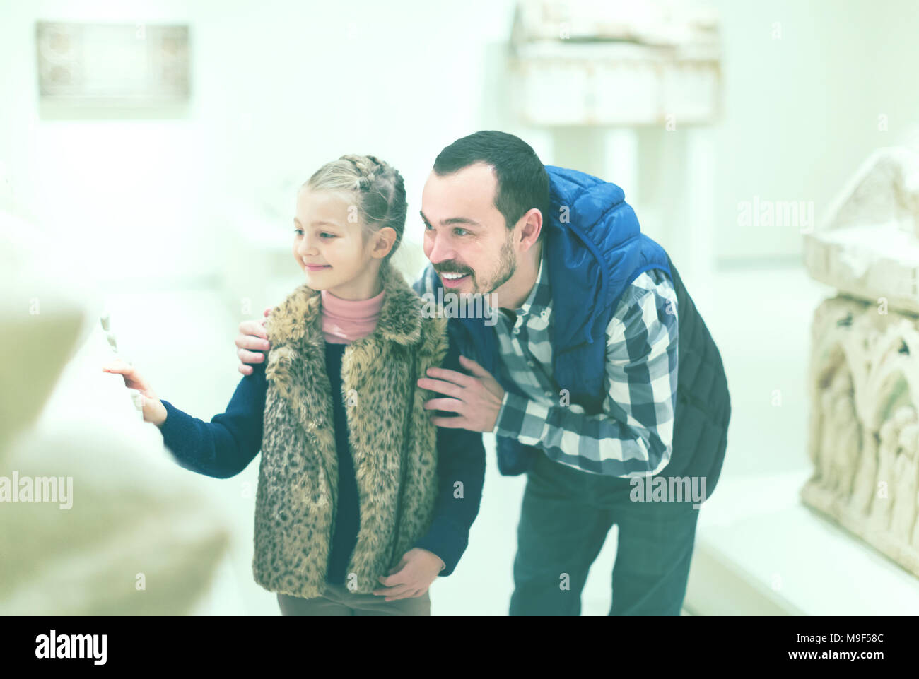 Young father and daughter exploring old bas-reliefs in museum Stock ...