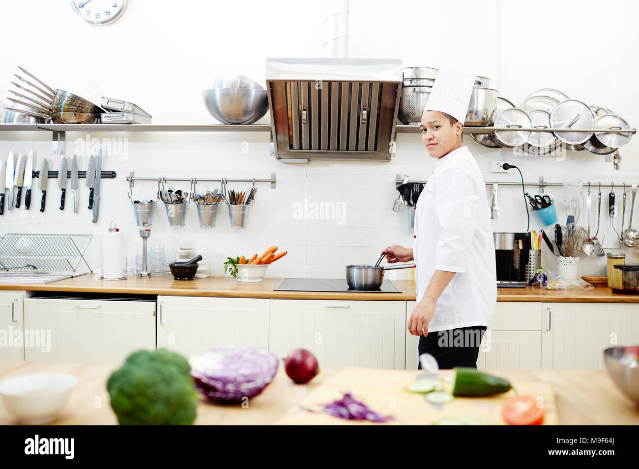Cooking on stove Stock Photo - Alamy