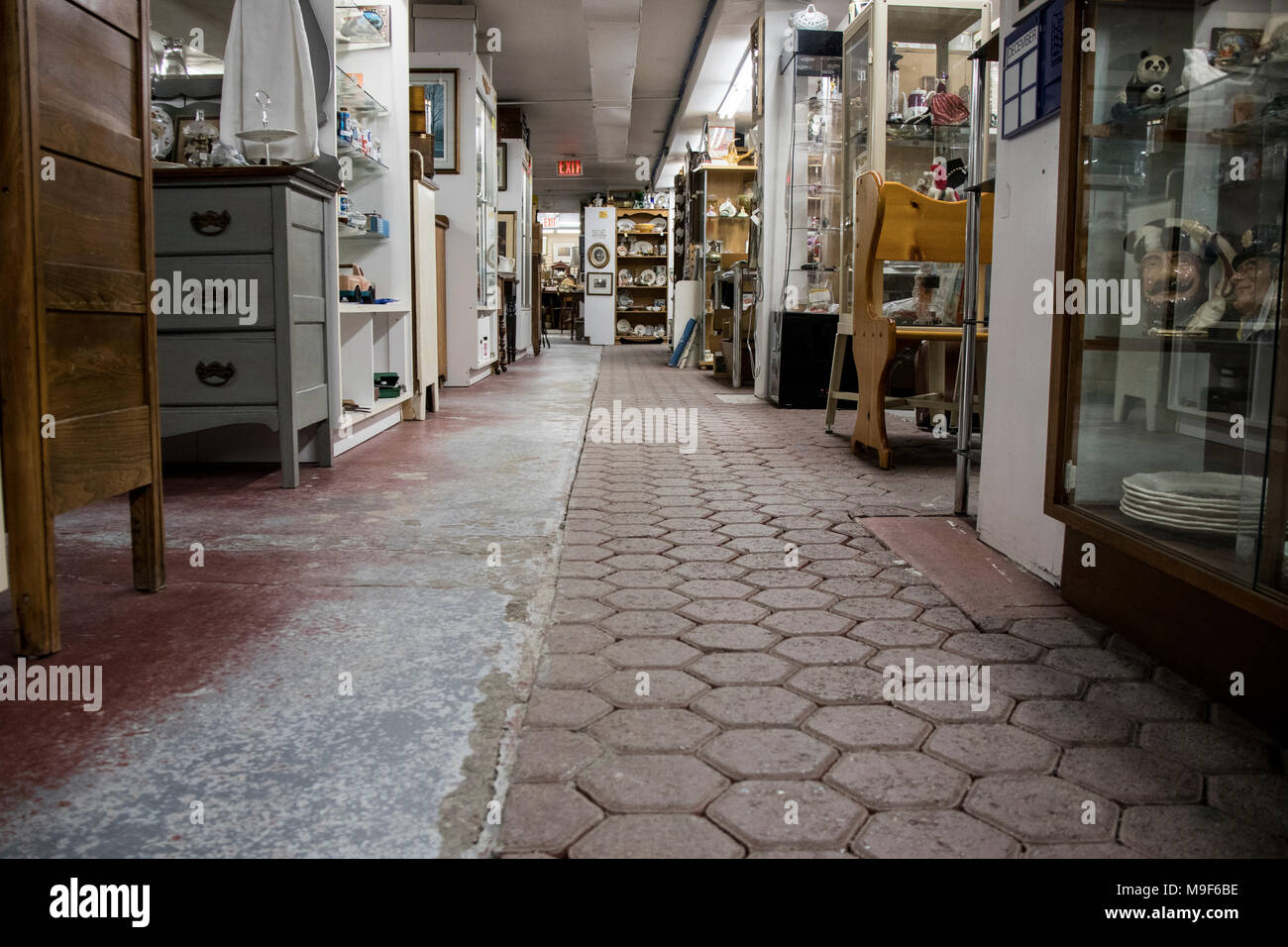 An interesting perspective looking down the aisle of an antique store ...
