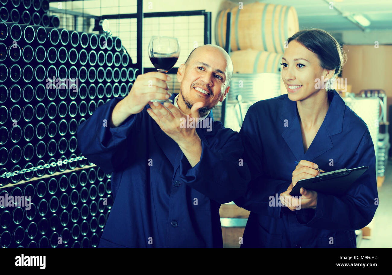 portrait of friendly smiling young woman expert standing with clipboard ...