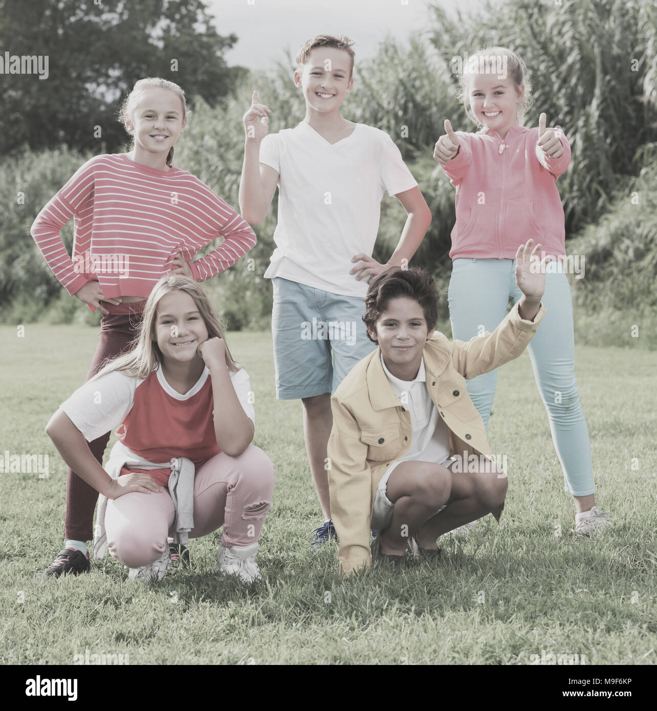 Portrait of five children who are walking and posing in the park Stock ...