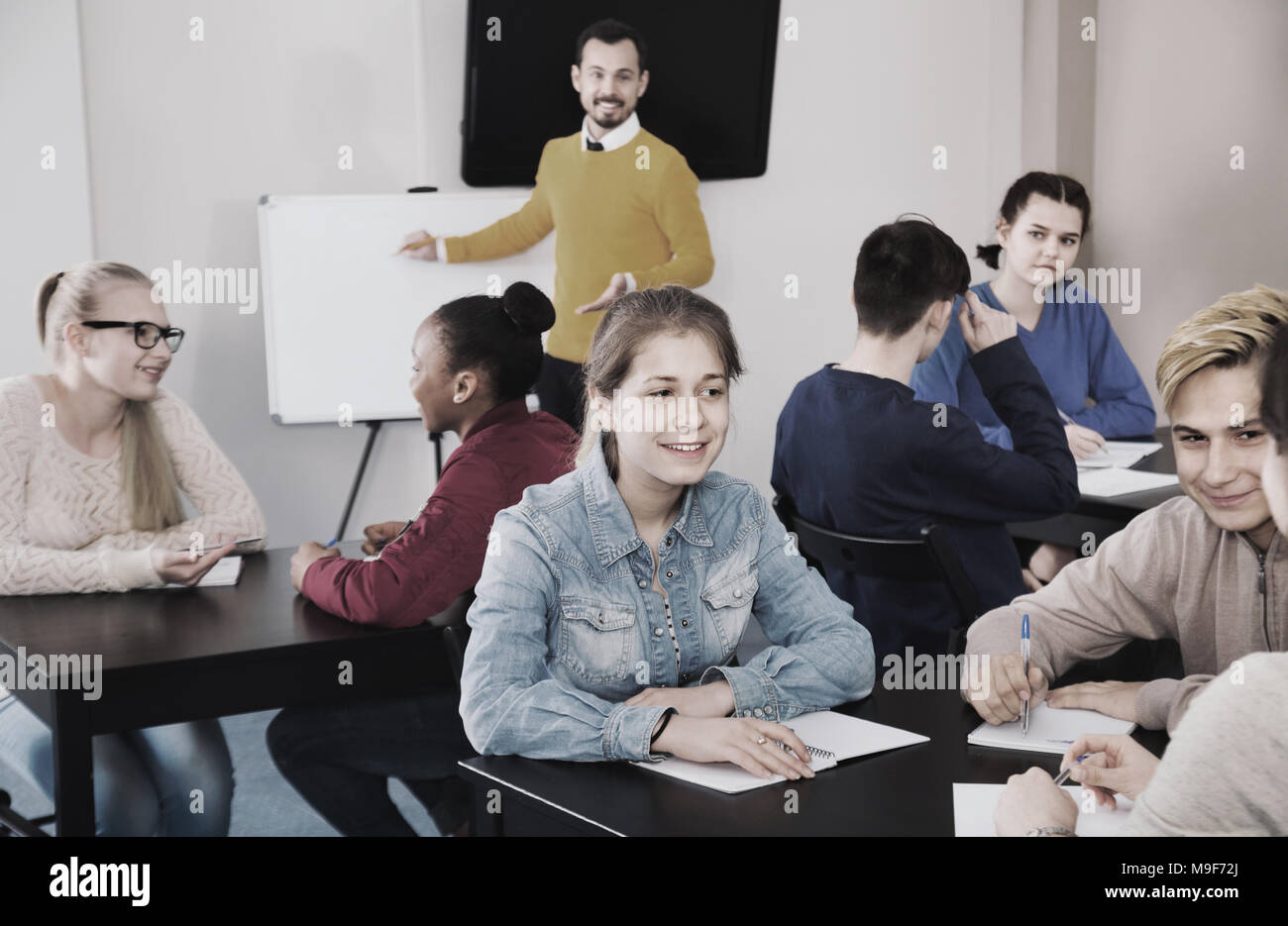 Diligent fellow students having group work tasks during school day ...