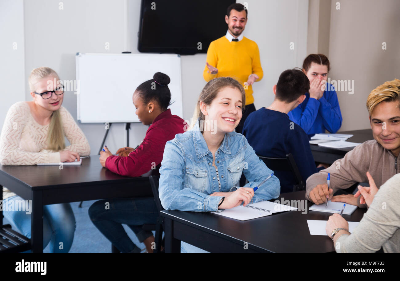 Teenage girls and boys are working in large groups in school Stock ...