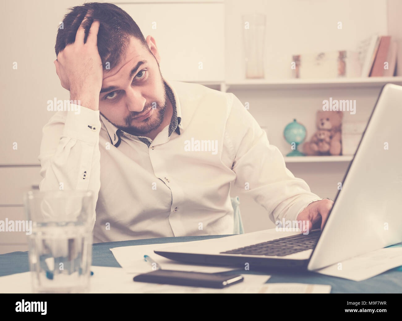 Stressed man worker facing challenge in project in office Stock Photo ...
