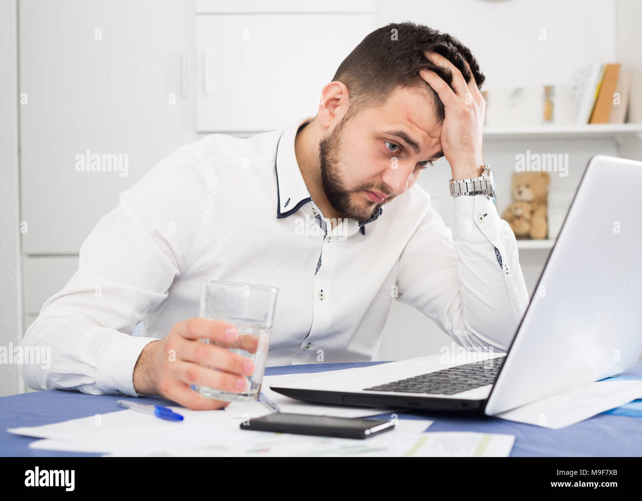 Stressed man worker facing challenge in project in office Stock Photo ...