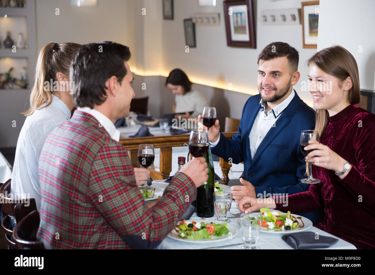 Friendly meeting over dinner with wine in restaurant Stock Photo - Alamy