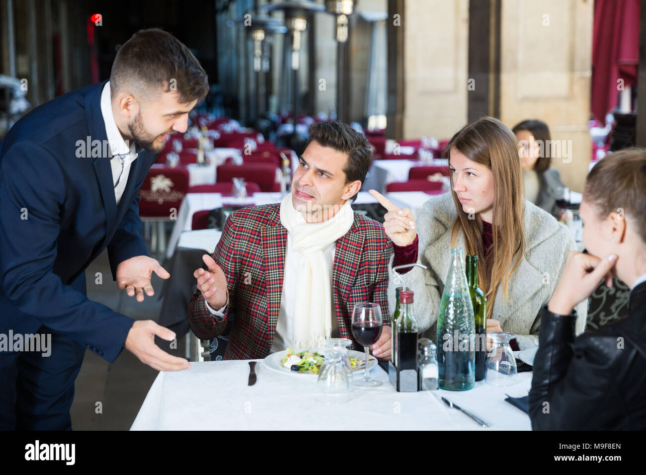 Dissatisfied people expressing displeasure with food and bad service to ...