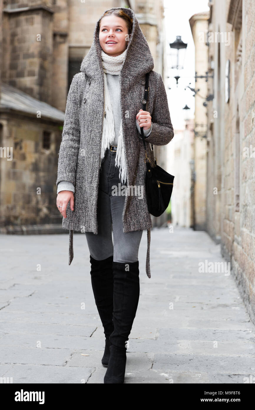 portrait of young female in the historical city center in hood Stock ...