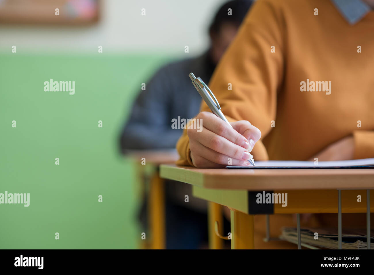 Students taking exam in classroom. Education test and literacy concept ...
