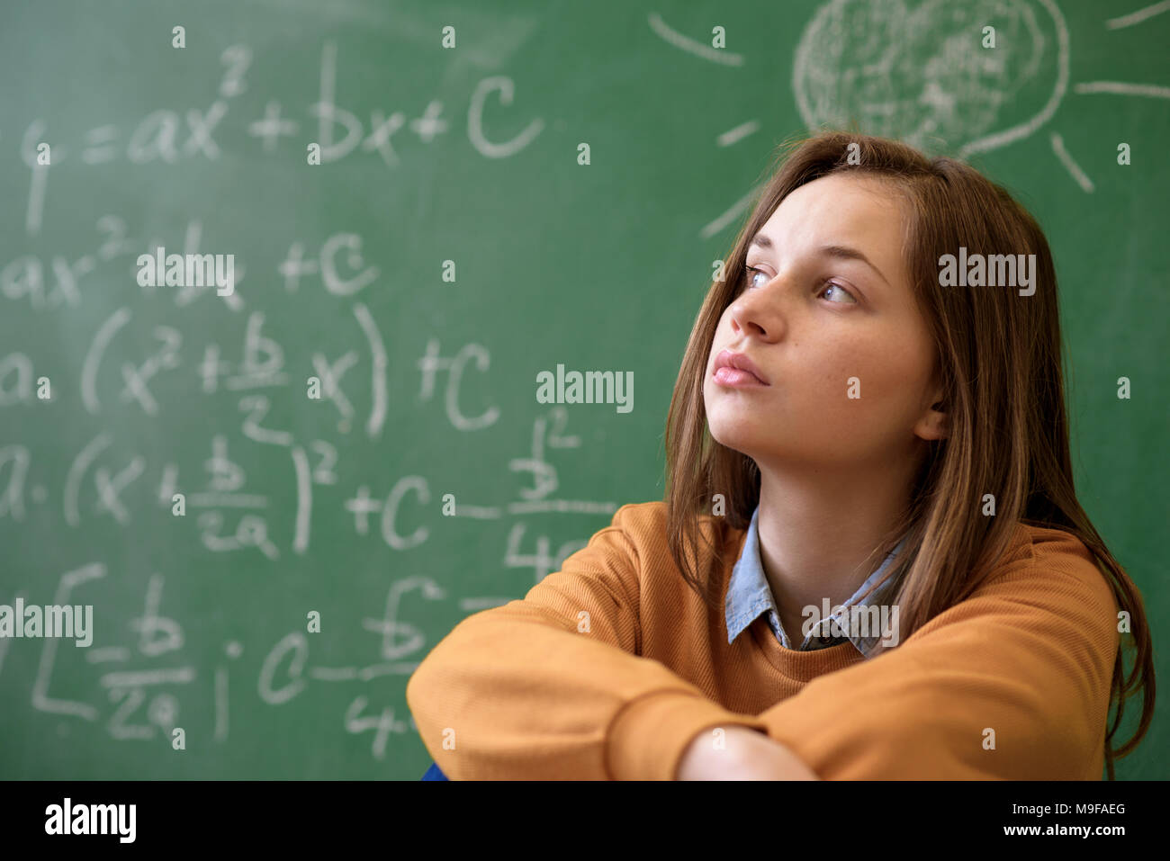 Teenager girl in math class overwhelmed by the math formula. Pressure ...