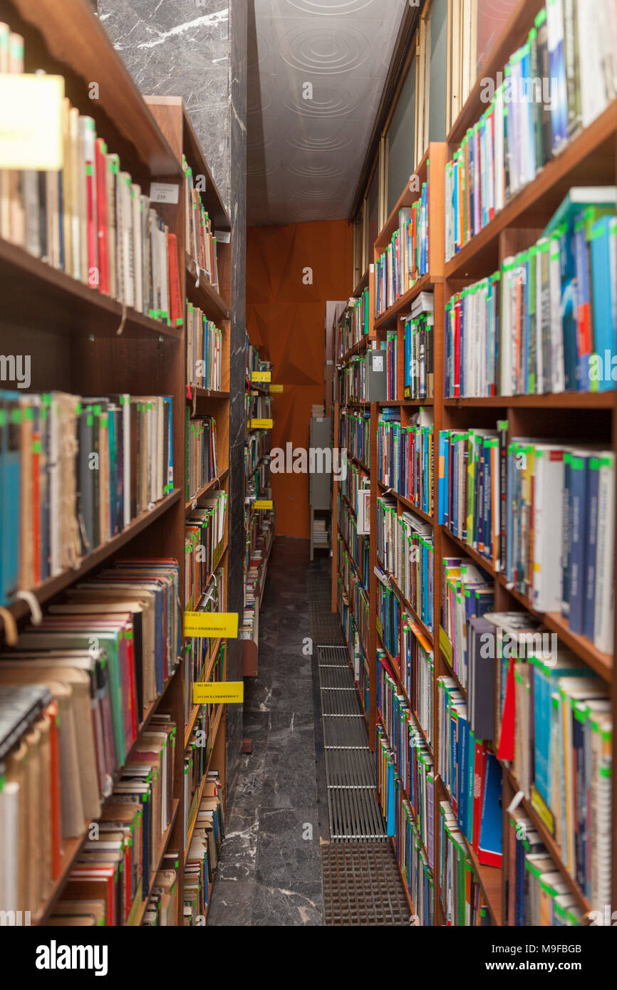 shelf with books in library Stock Photo - Alamy