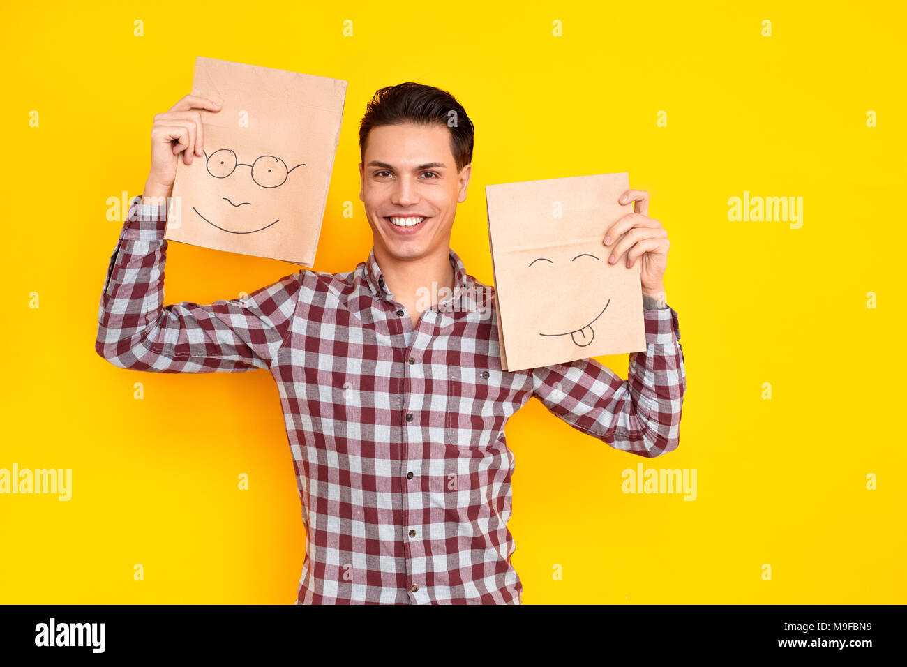 Man holding painted funny face and toothy smiling. Fool's day emotions ...