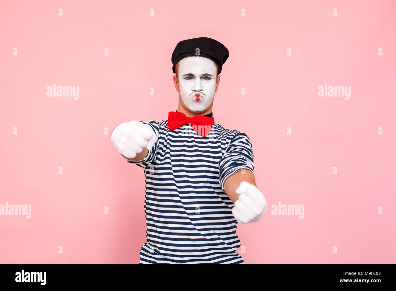 Closeup portrait of driver man ride a car. Clown, artist , mime. Studio ...
