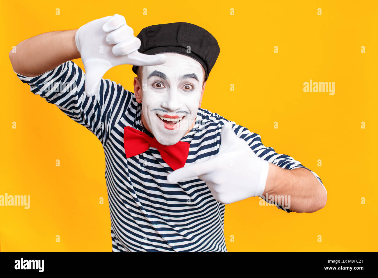 Toothy smiling mime man making fingers frame . Emotions and feelings ...