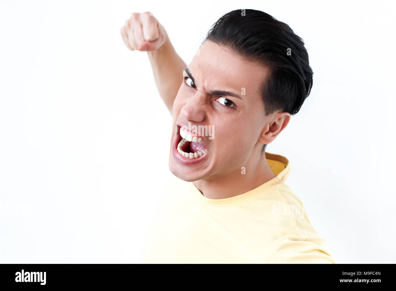 Portrait of danger man, roar and shout and bow at camera. Emotions and ...