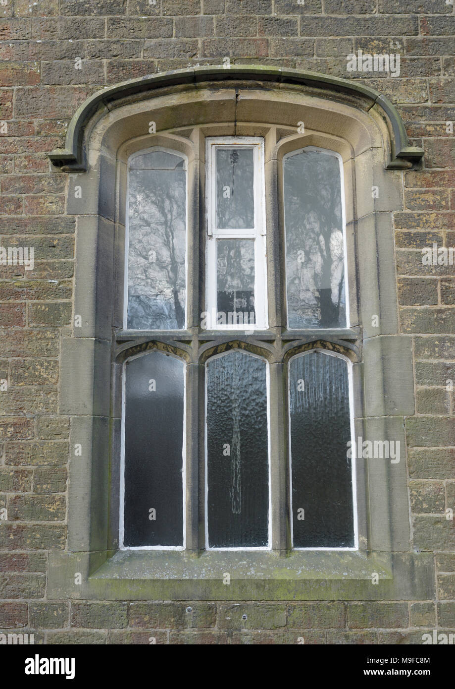 Arched window with stone mullions in Haworth village west yorkshire ...