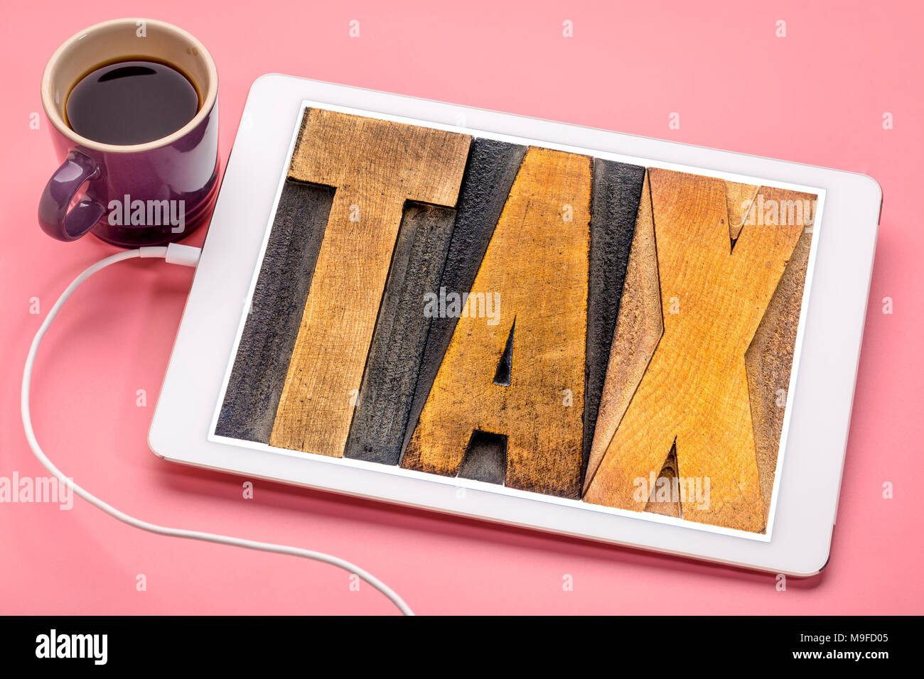 tax concept - text in vintage letterpress wood type on a digital tablet ...