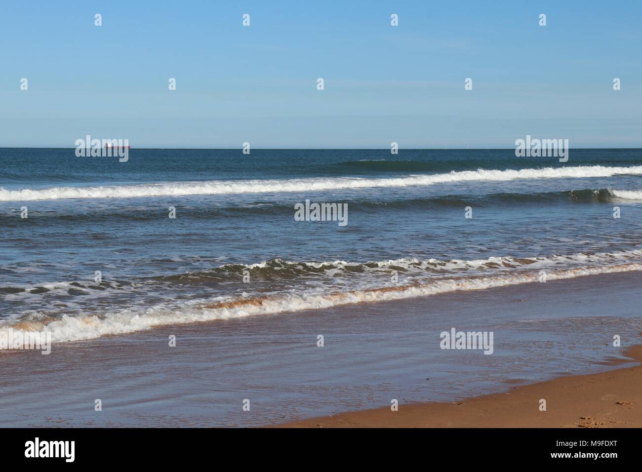 Waves arriving on beach Stock Photo - Alamy