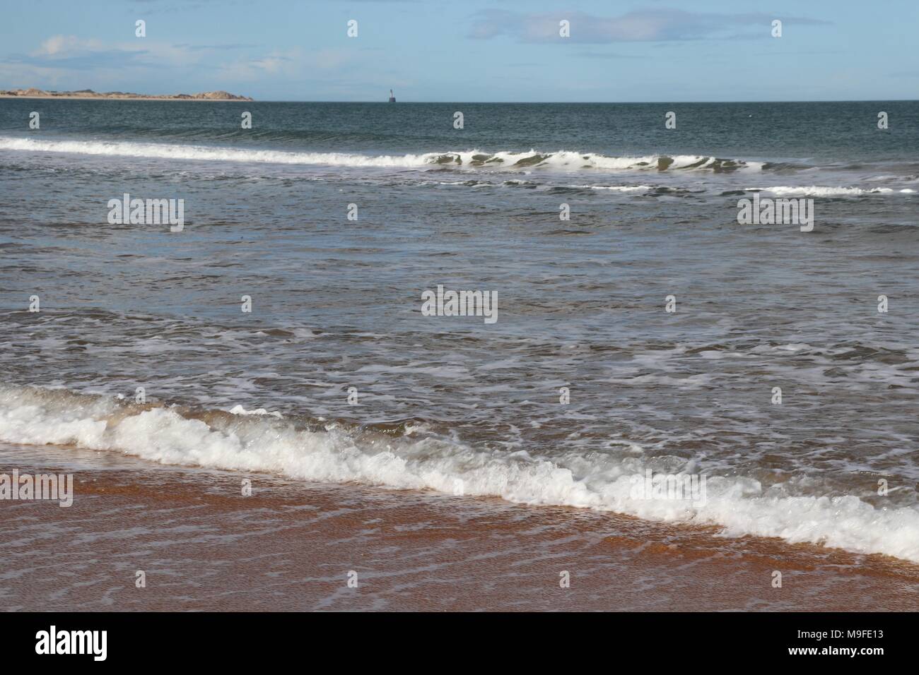 Waves arriving on beach Stock Photo - Alamy