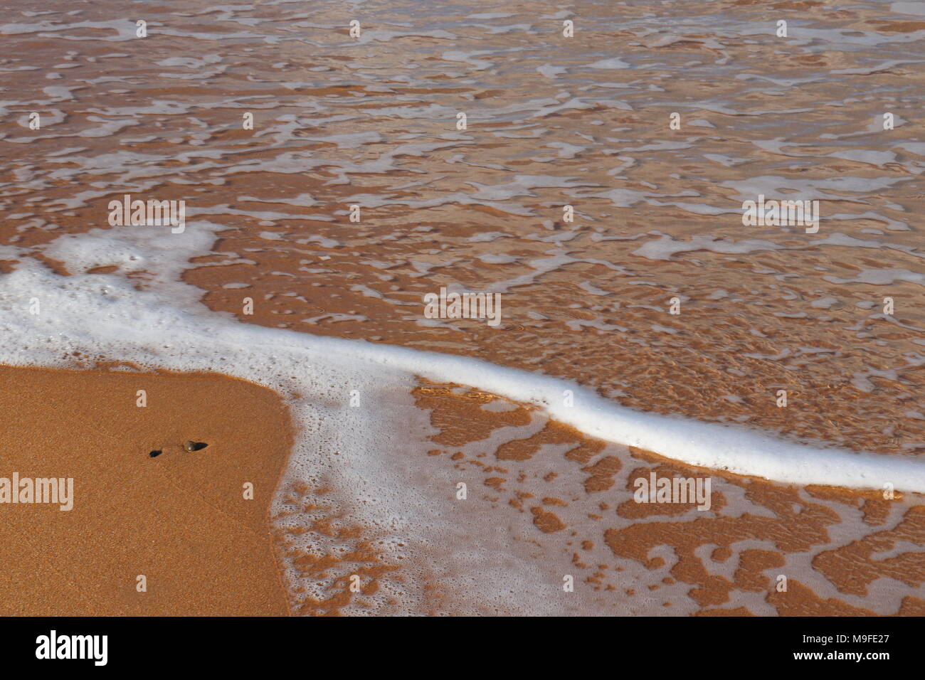 Waves arriving on beach Stock Photo - Alamy