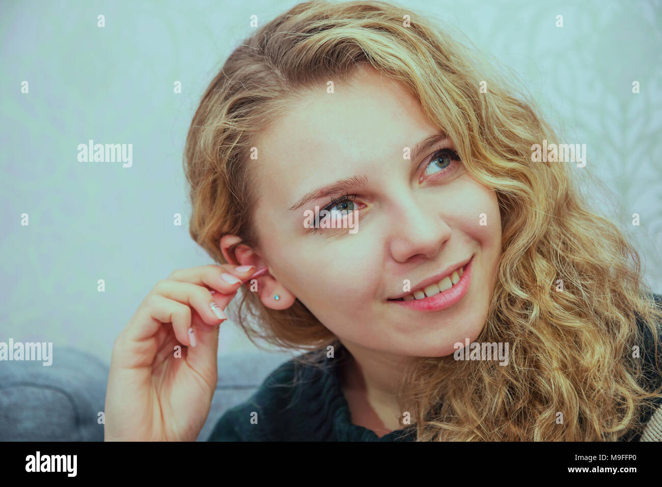 beautiful girl brushing her ears, prevention of health, the concept of ...