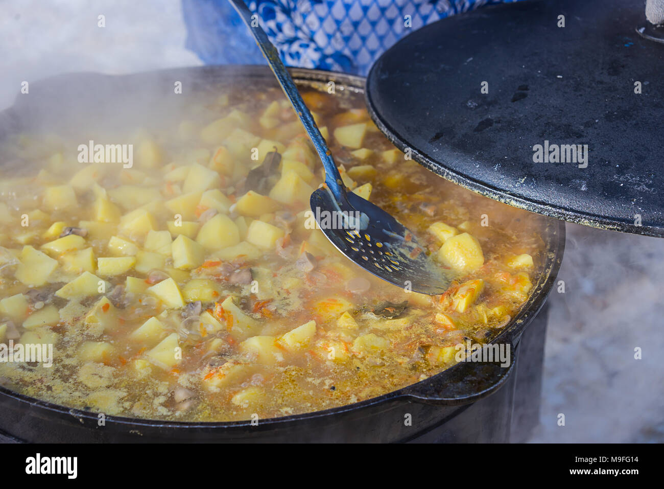 potatoes stewed in a boiler, outdoors, feeding homeless people, social ...