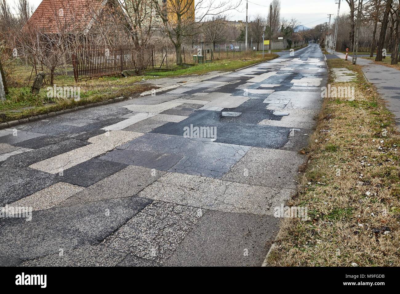Patched broken road Stock Photo - Alamy