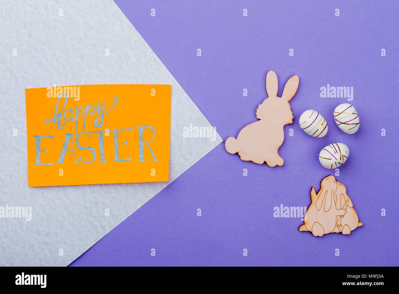 Plywood rabbit cutouts on colorful background. Easter wooden bunnies ...