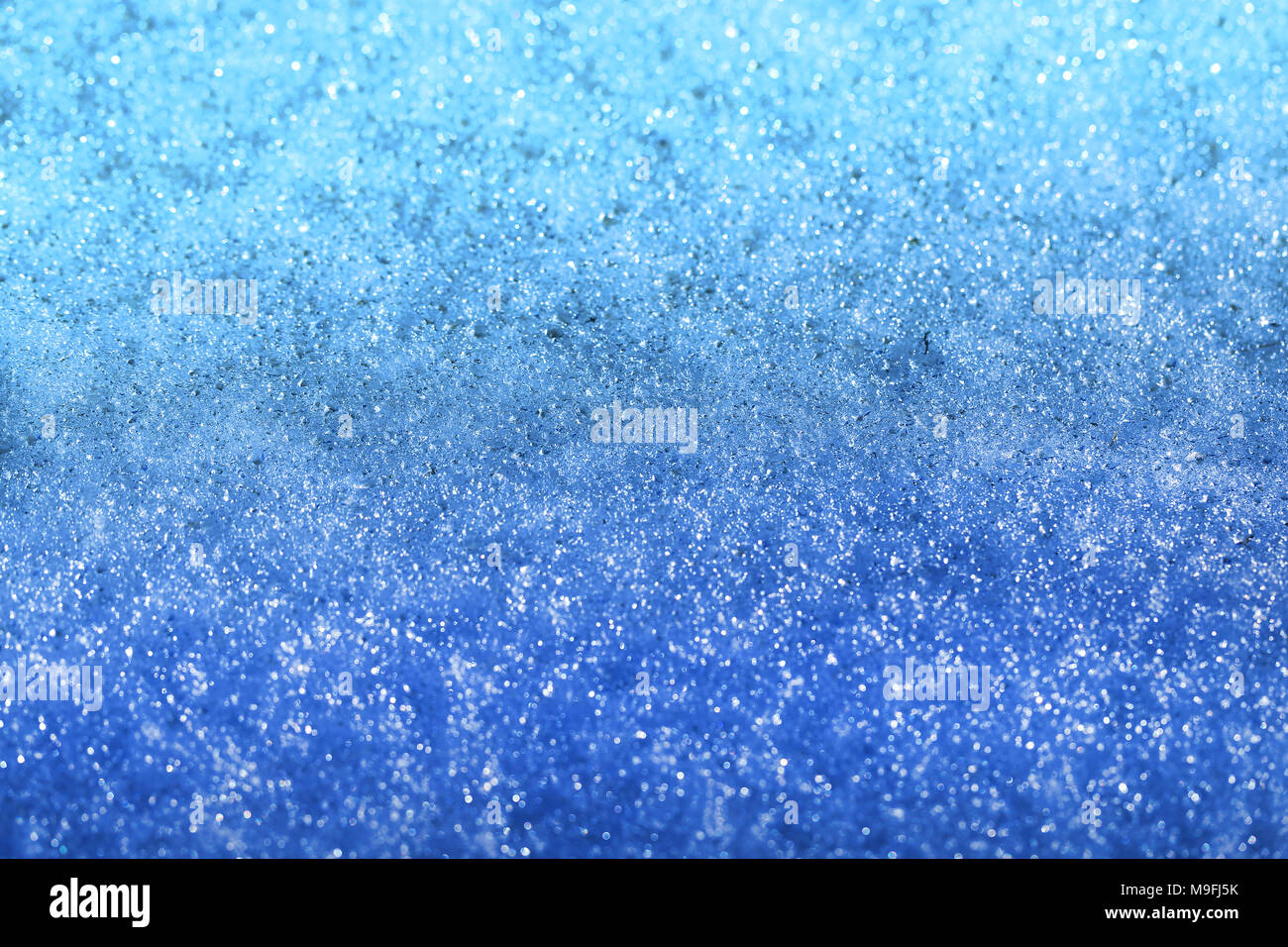 Photo of a background of blue melting snow illuminated by the sun Stock ...