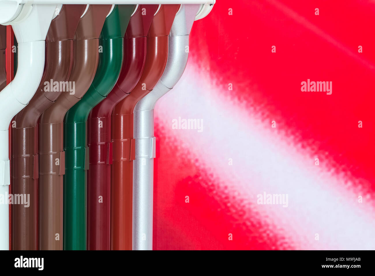 multicolored drain pipes on the exhibition, background image with space ...