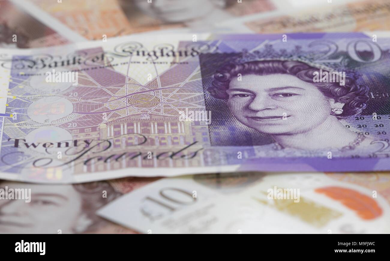 Bank of England £20 cotton paper banknote on top of the new polymer £10 ...