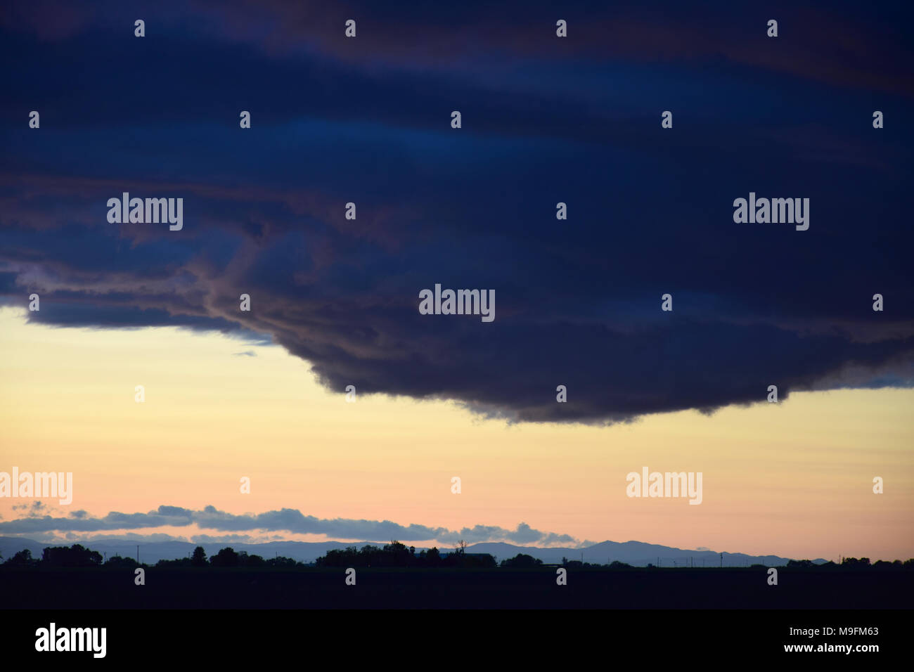 Dark clouds in a stormy sky at dusk Stock Photo - Alamy