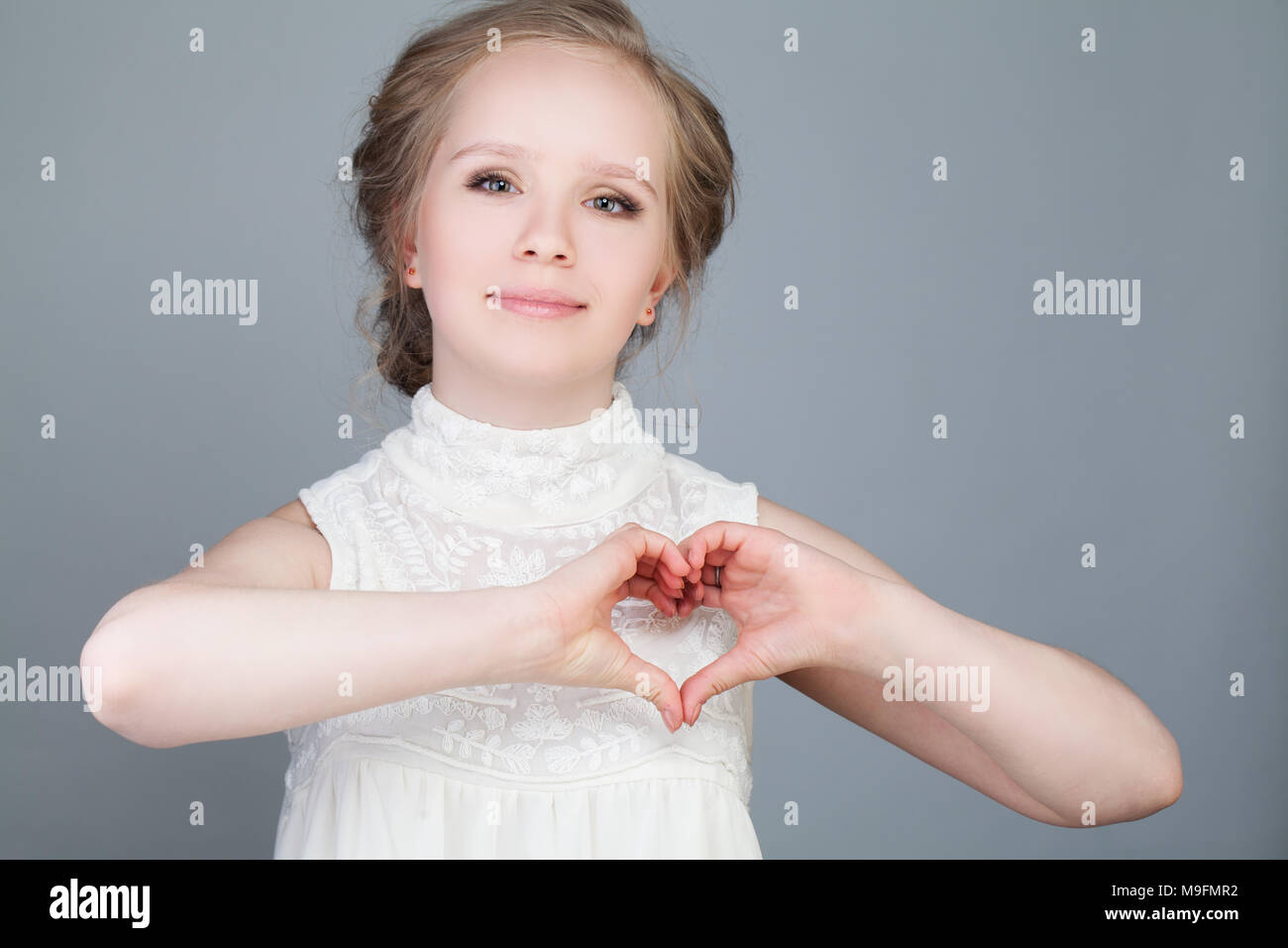 Happy Fashion Model Girl Making Heart. Love Concept Stock Photo - Alamy