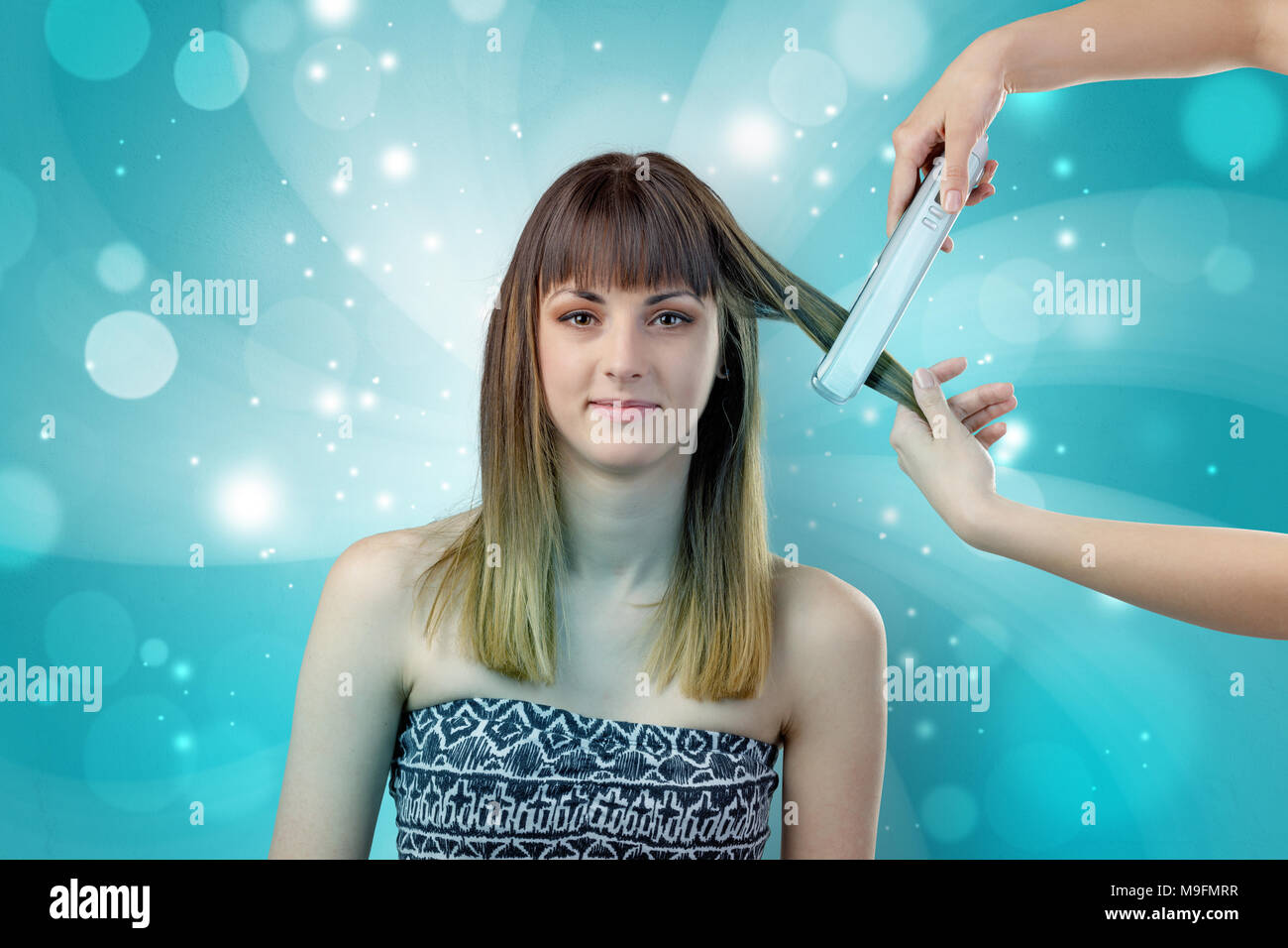 Graceful brunette woman getting ready with shiny turquoise wallpaper ...