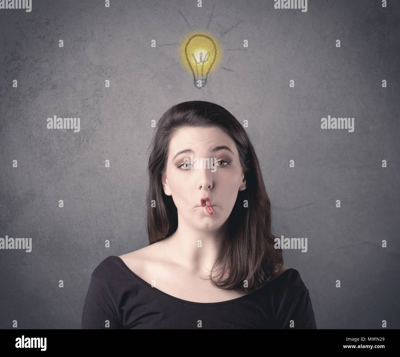 A teen student girl with funny facial expression has a good idea ...