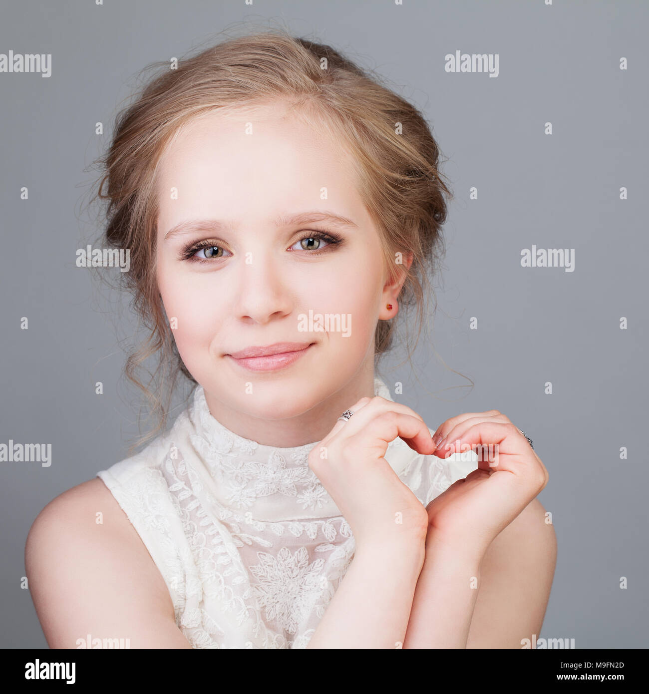 First Love. Cute Girl Smiling and Making Heart Stock Photo - Alamy