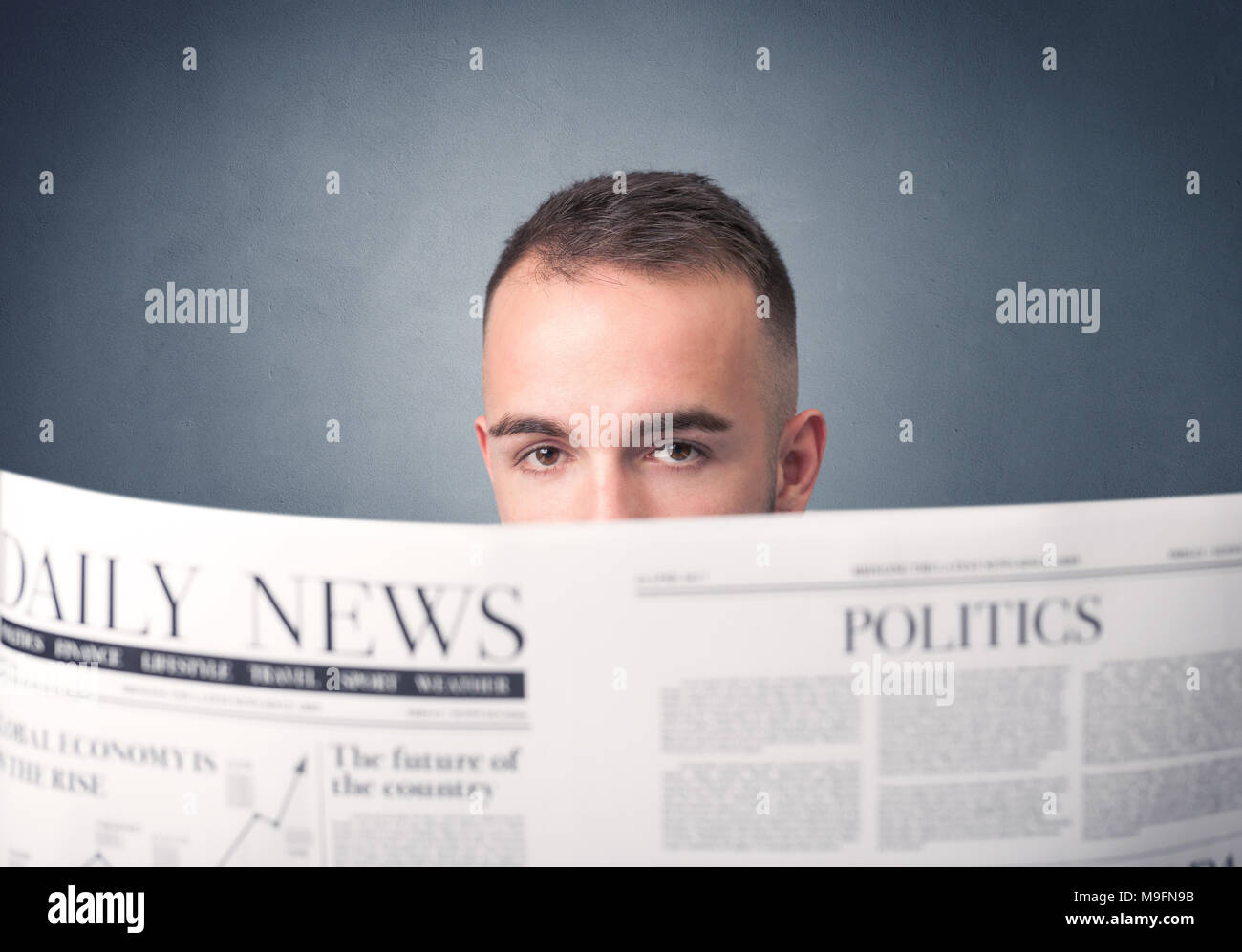 Young smart businessman reading daily newspaper Stock Photo - Alamy