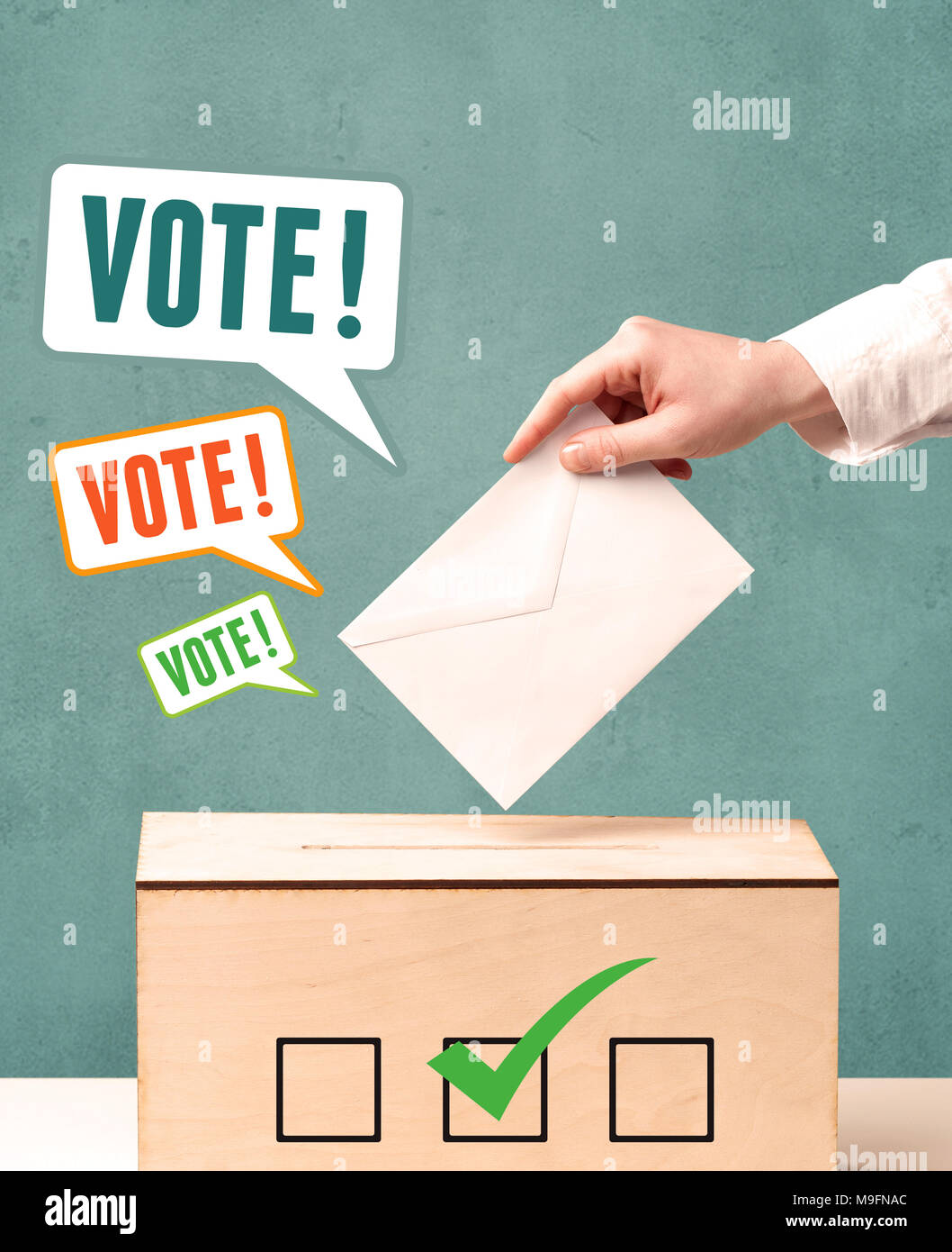 A hand placing a voting slip into a ballot box Stock Photo - Alamy