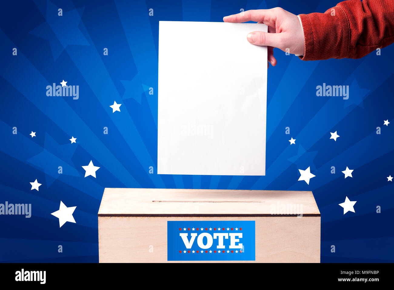 Voting hand with ballot and wooden box Stock Photo - Alamy