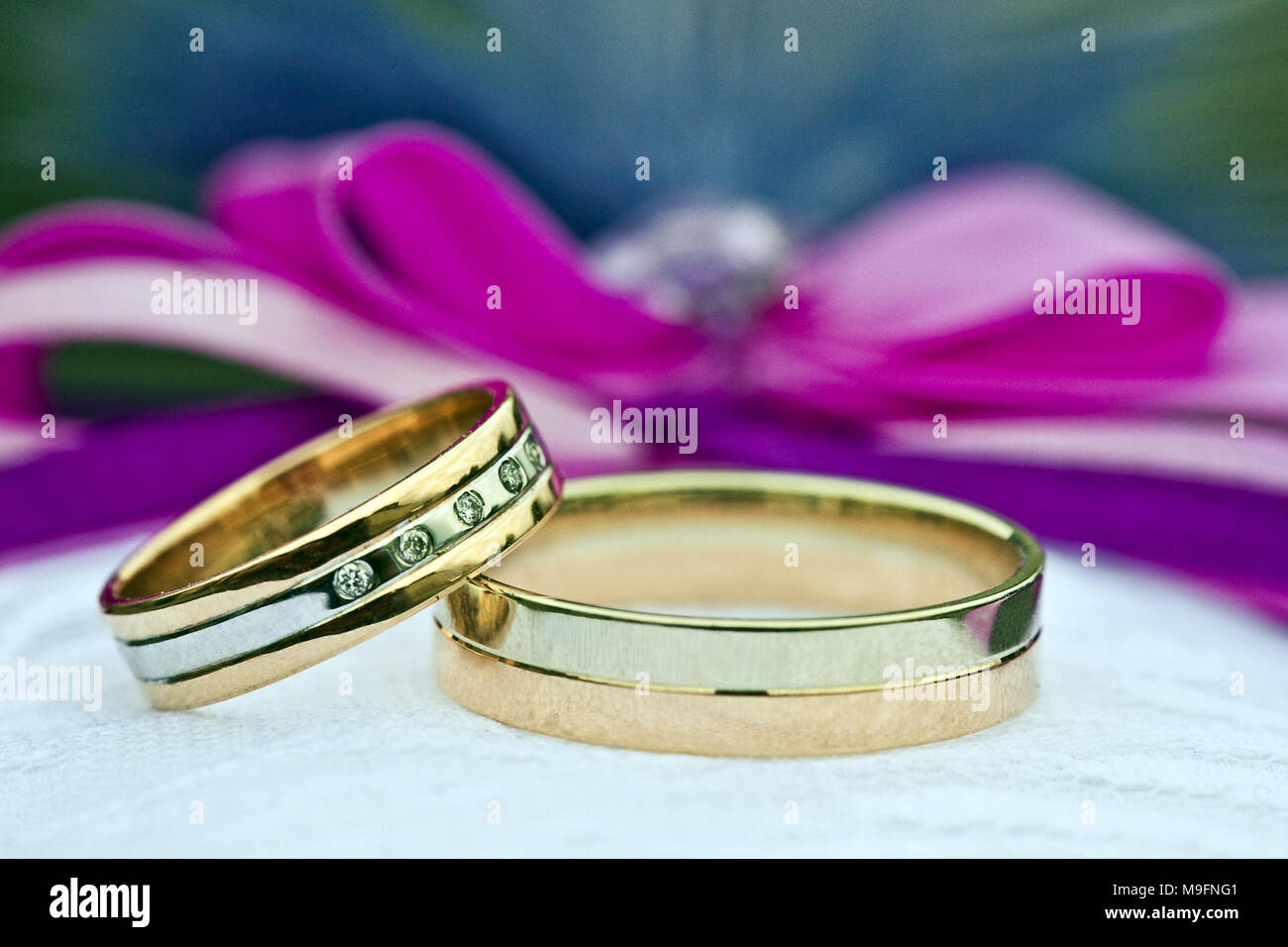 Two gold wedding rings of white and yellow gold Stock Photo - Alamy
