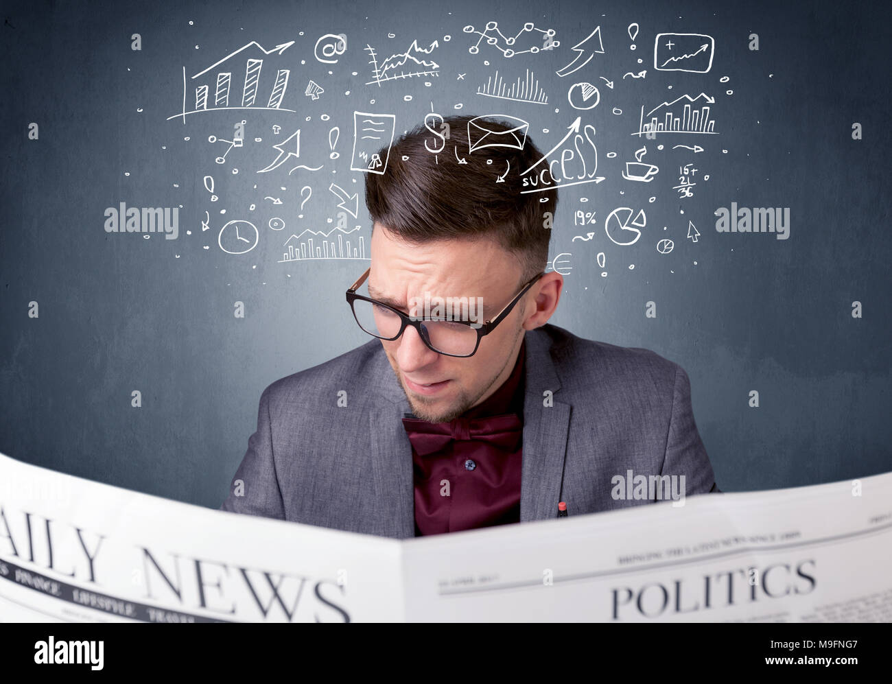 Young smart businessman reading daily newspaper with business plan ...