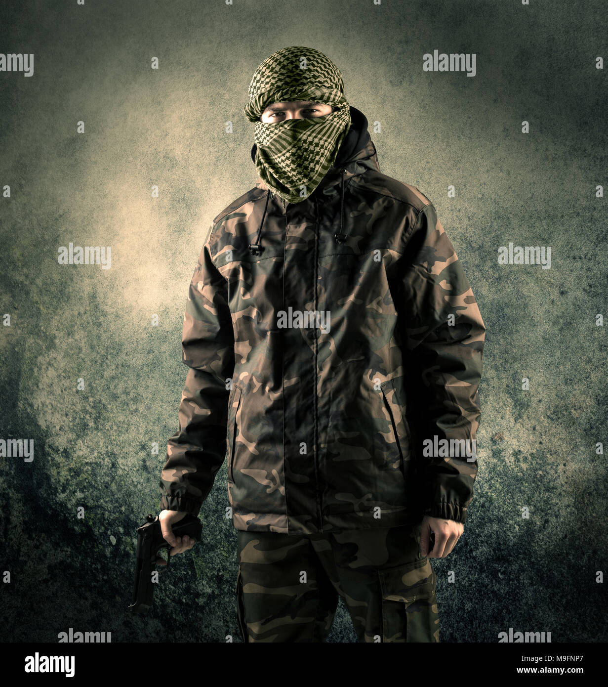 Portrait of a heavily armed masked soldier with grungy background ...