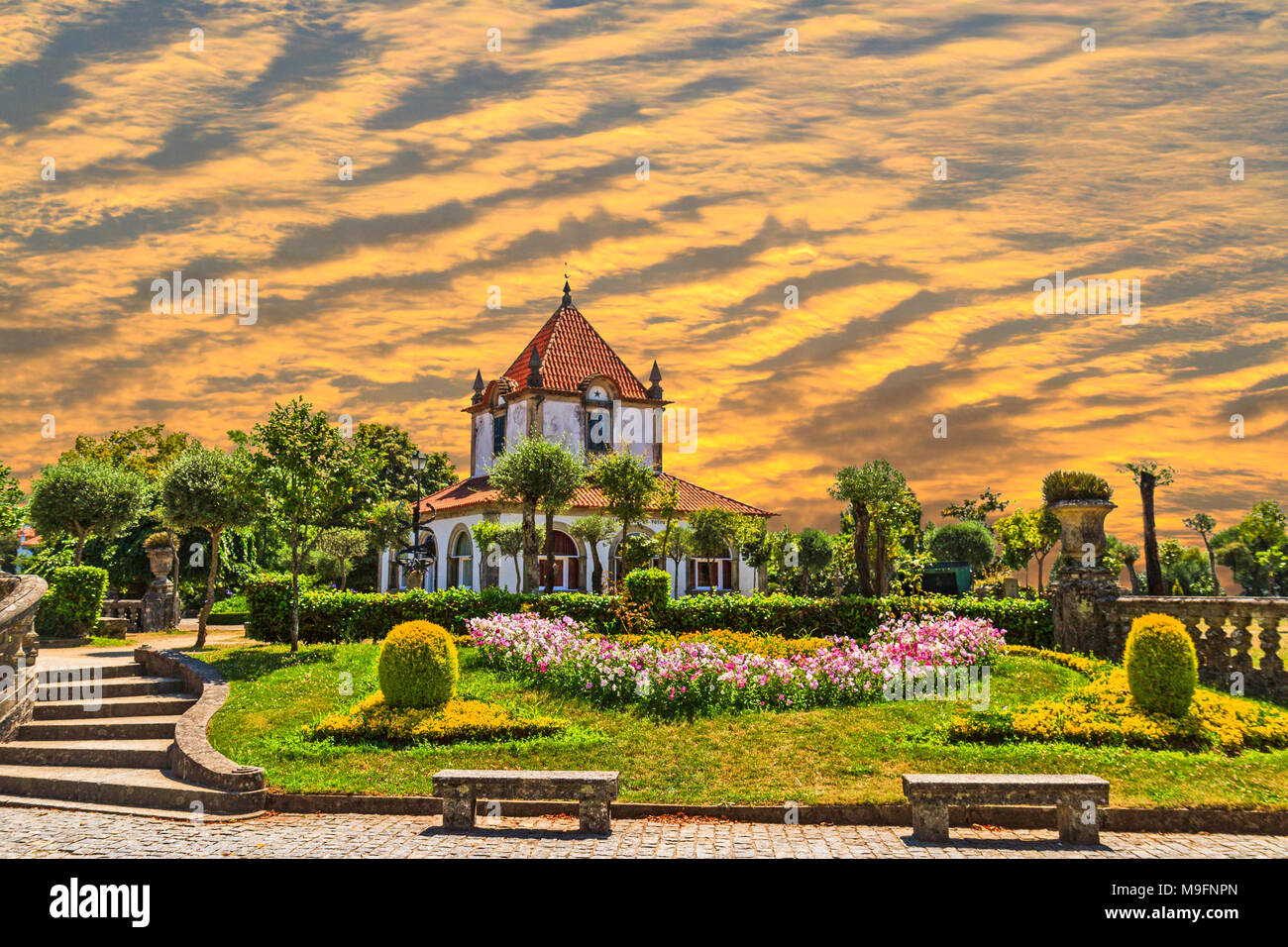 lovely house with a beautiful garden at sunset, buildings and a place ...