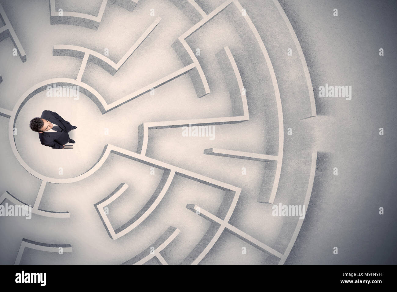 Confused business man trapped in a circular maze Stock Photo - Alamy