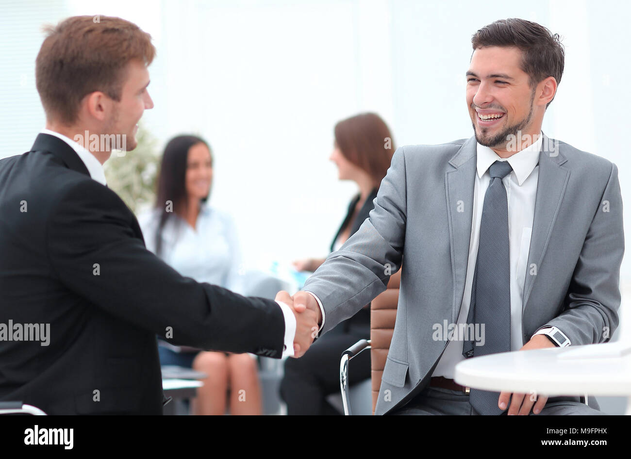 handshake Manager and the client in the office Stock Photo - Alamy