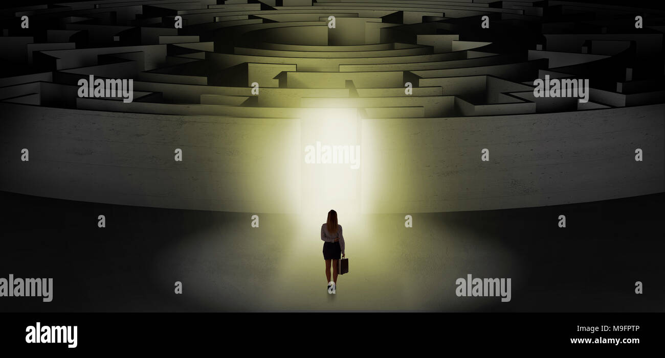Woman getting ready to enter a concentric labyrinth with lighted ...