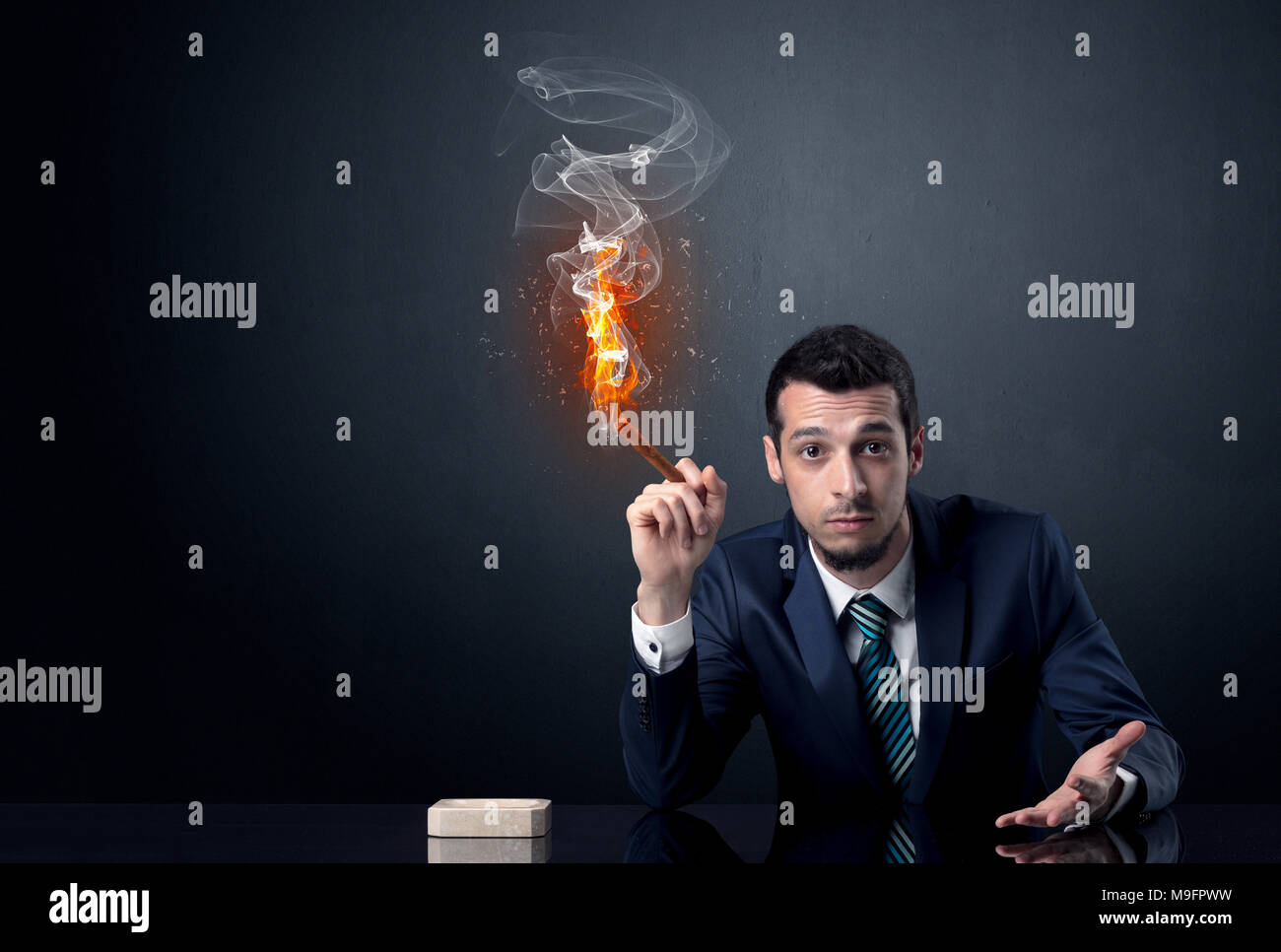 Businessman smoking with inferno effect Stock Photo - Alamy